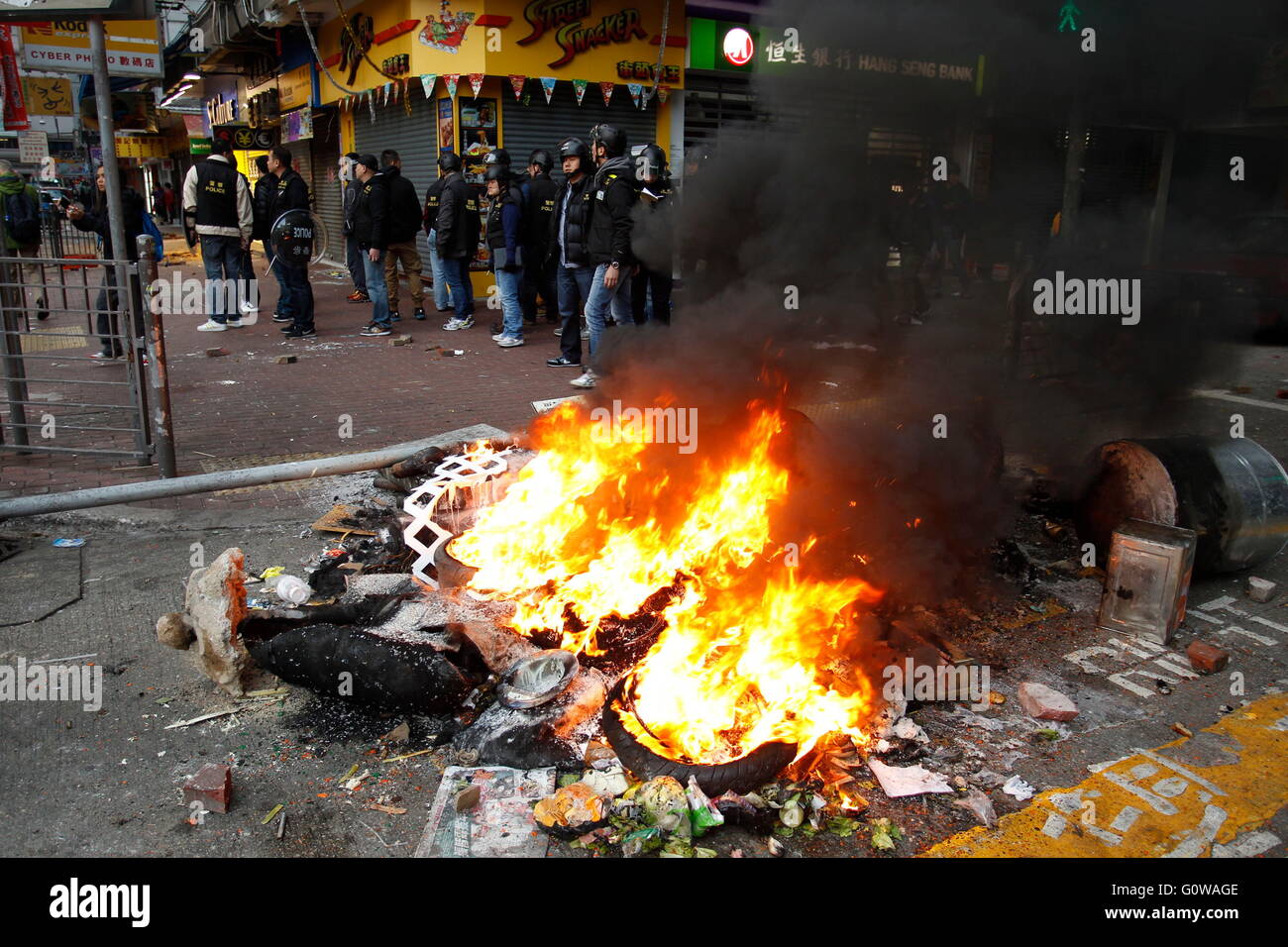 Hong Kong, China. 9th Feb, 2016. Debris burn on the street of Mong Kok ...