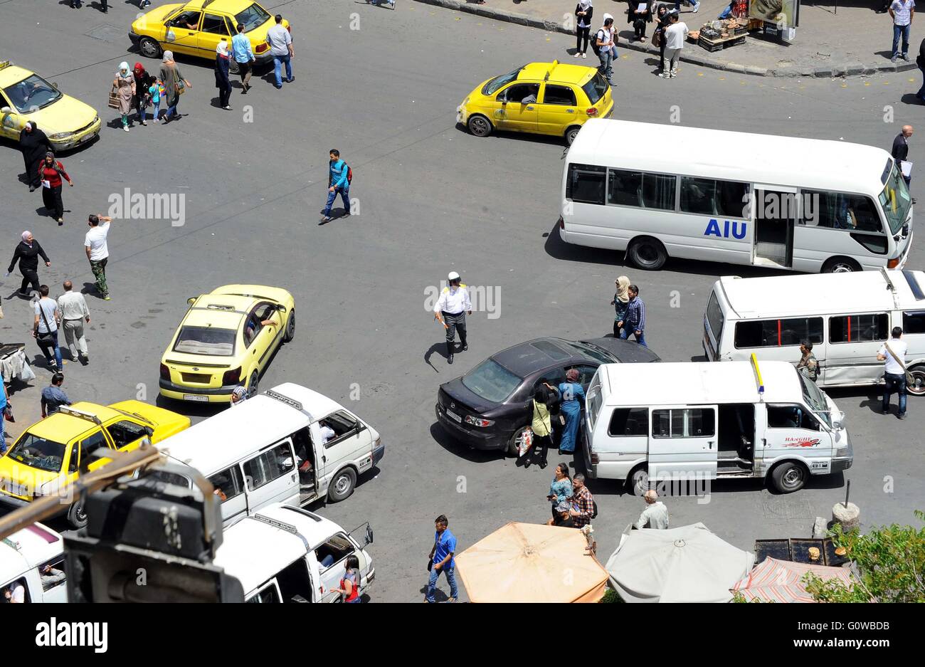 Damascus, Syria. 4th May, 2016. A Syrian traffic police officer directs ...