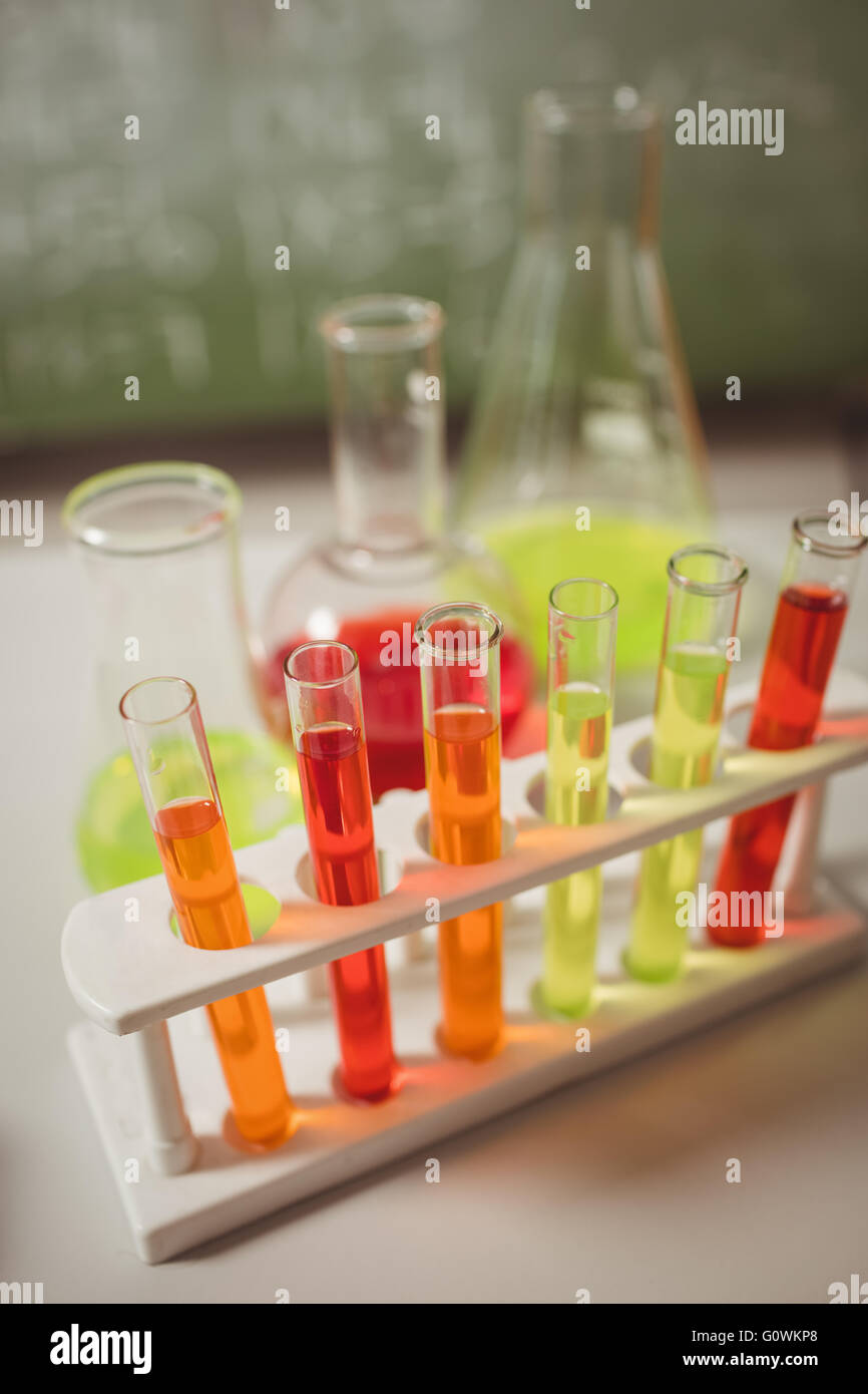 Test tube and beaker on desk Stock Photo - Alamy