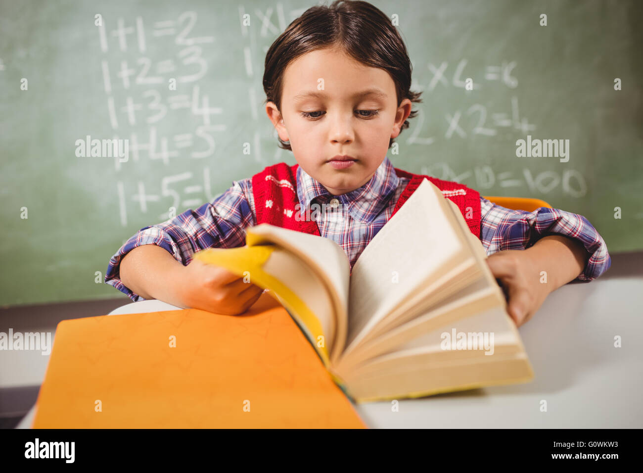 A little boy reading a book Stock Photo - Alamy