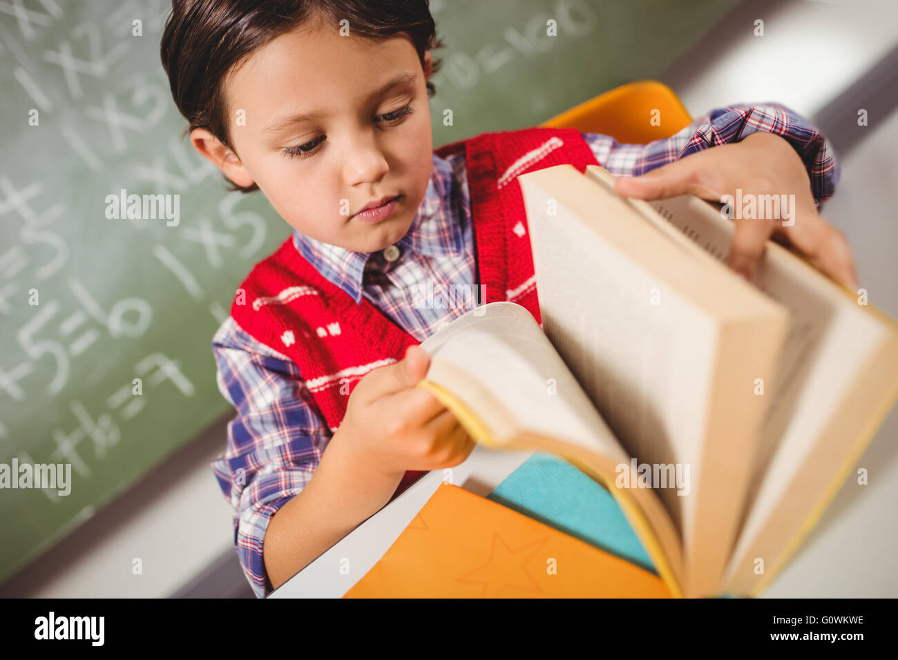A little boy reading a book Stock Photo - Alamy