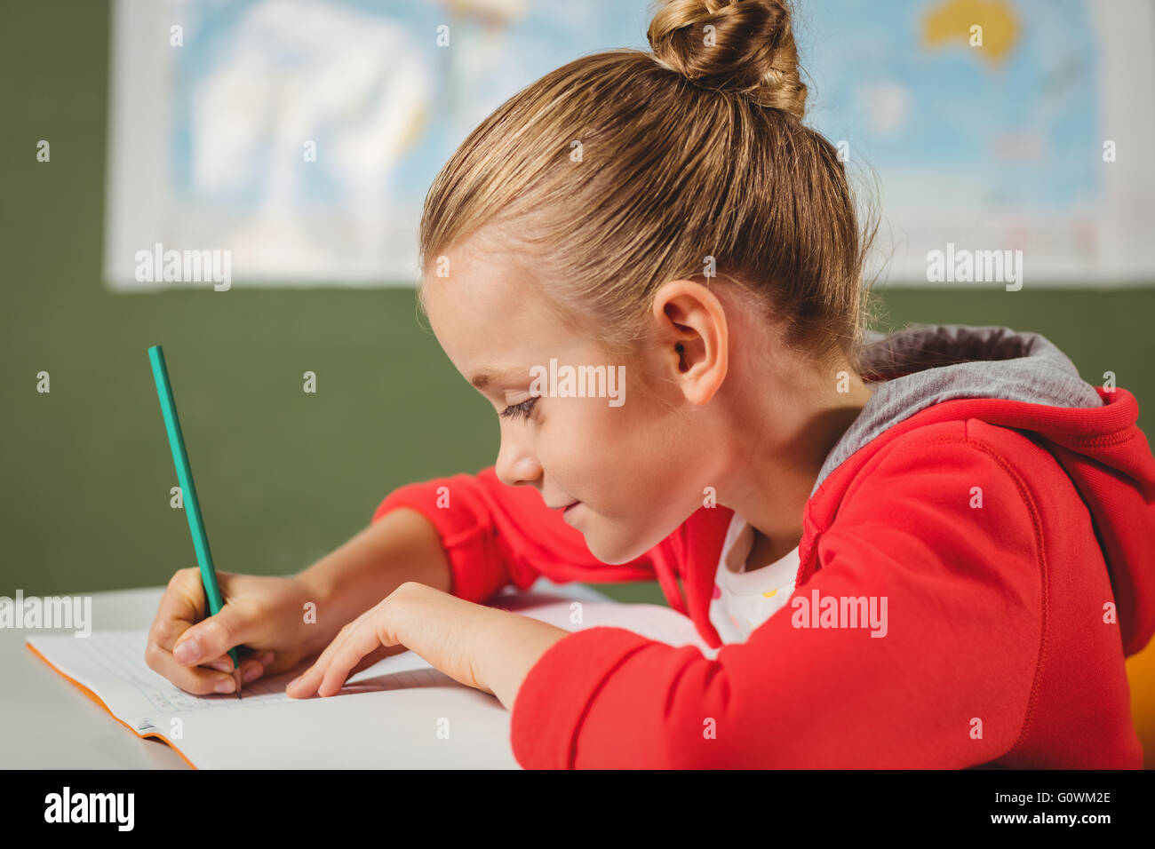 Girl writing in her notebook Stock Photo - Alamy