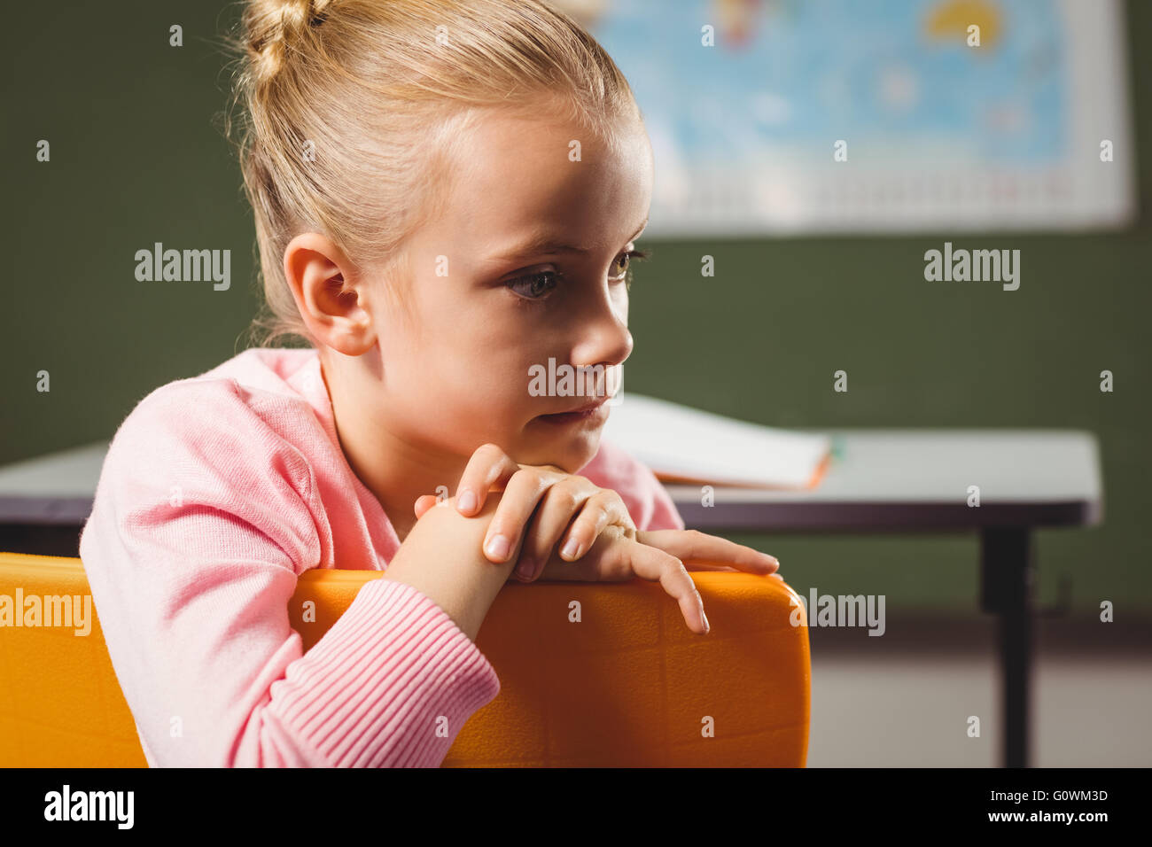 Girl leaning against chair Stock Photo - Alamy