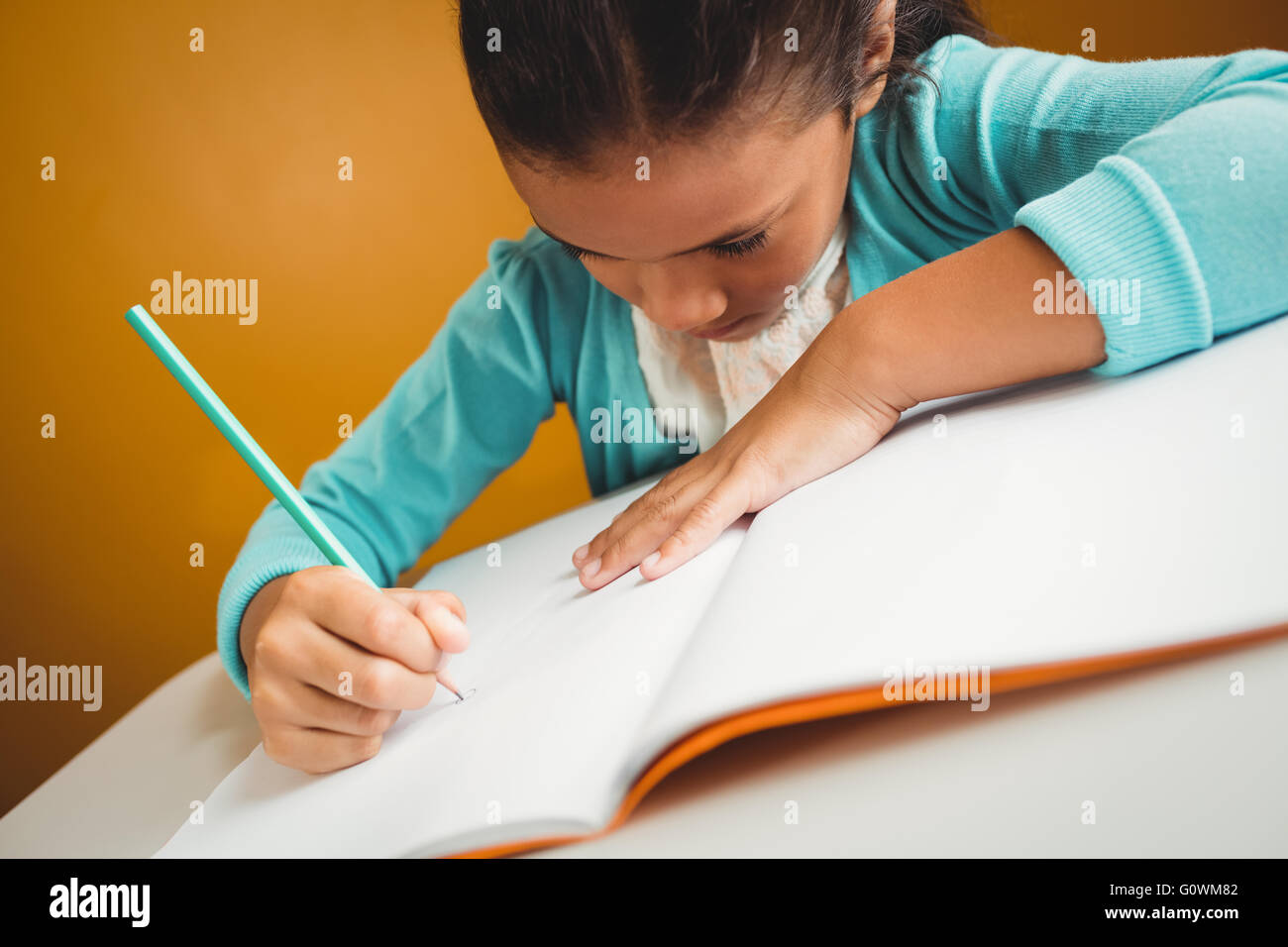 Girl writing in her notebook Stock Photo - Alamy