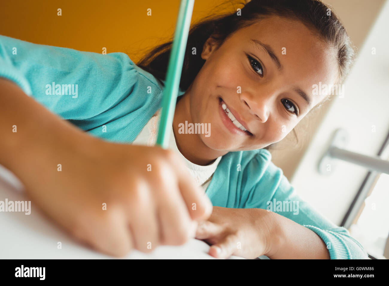 Girl writing in her notebook Stock Photo - Alamy