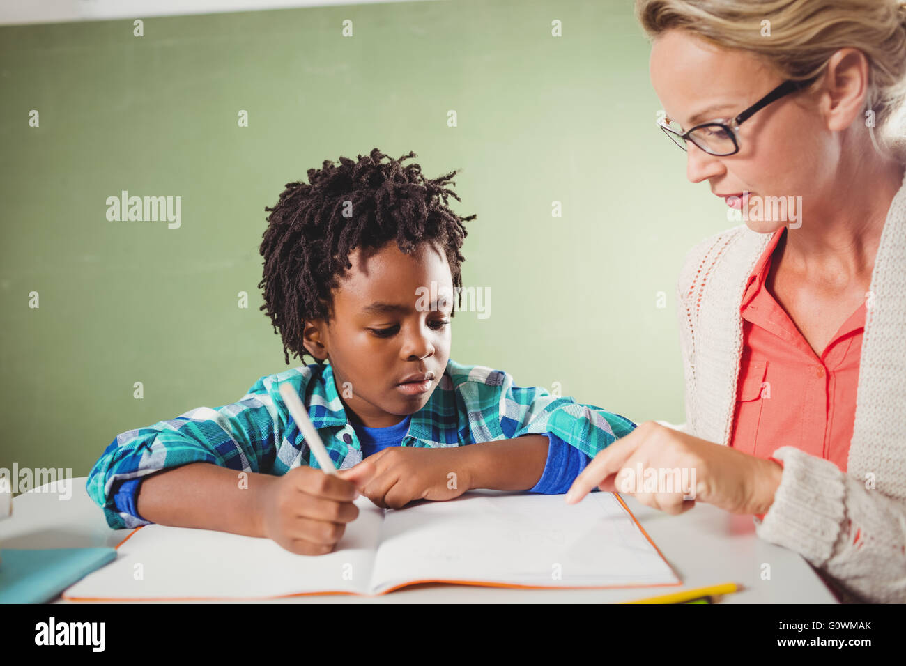 Mature female teacher explaining hi-res stock photography and images ...