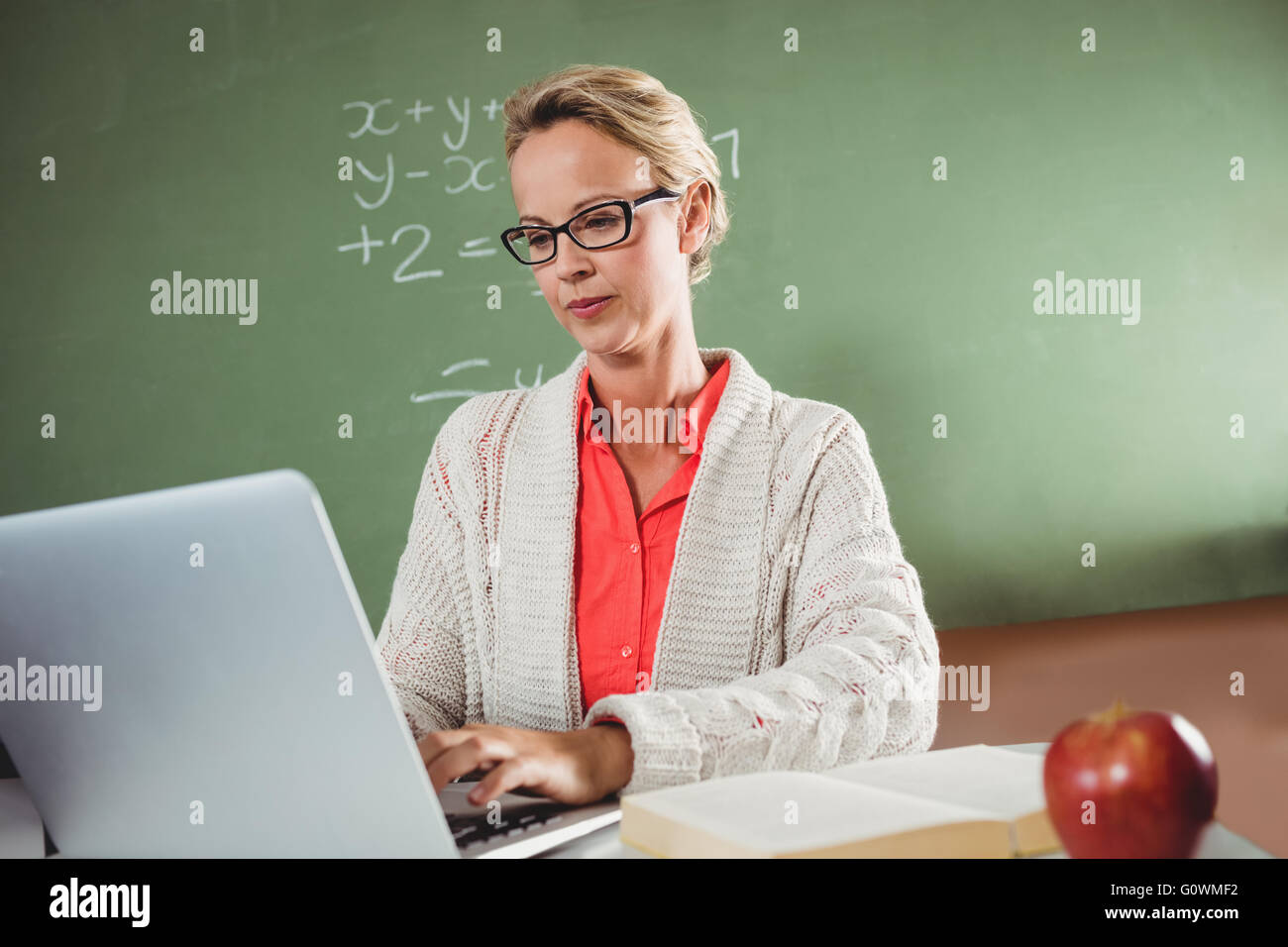 Teacher using a laptop Stock Photo - Alamy