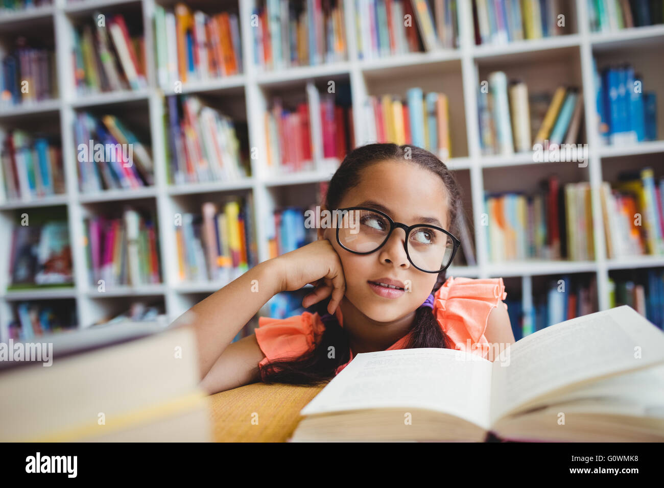 Girl sitting at a desk Stock Photo - Alamy