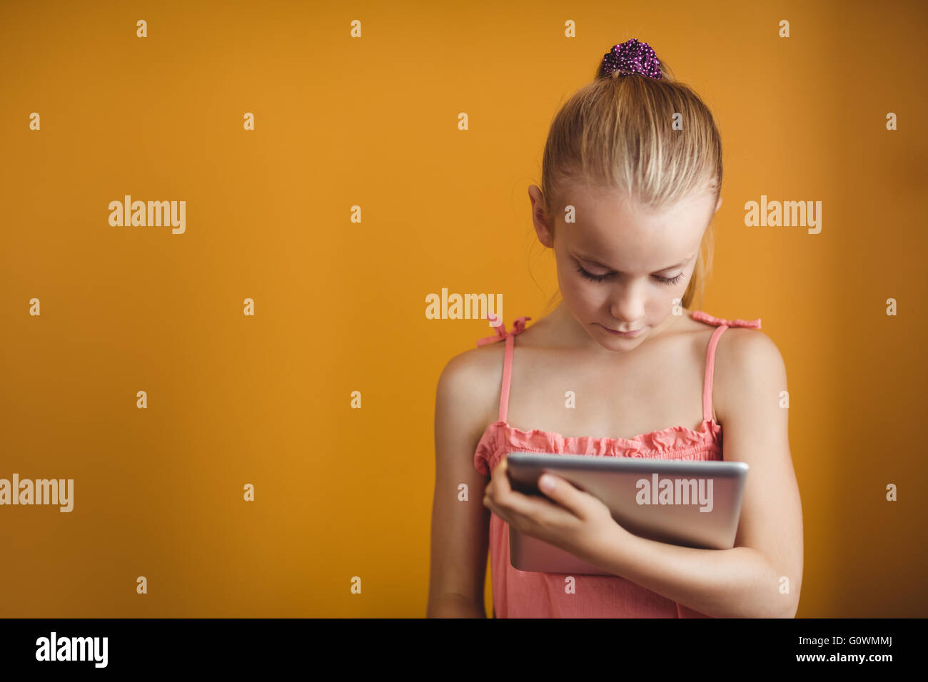 Little girl using a tablet Stock Photo - Alamy