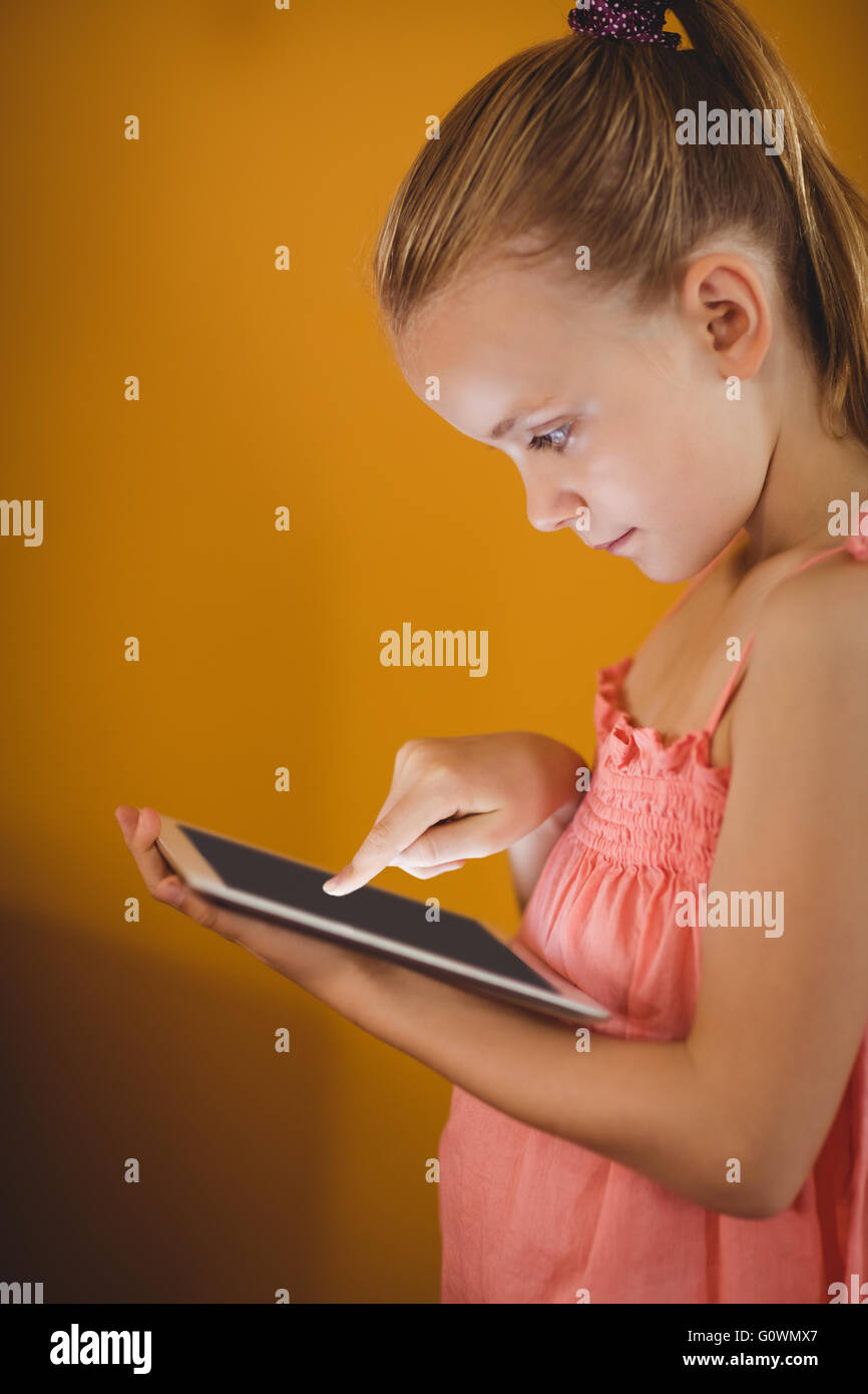 Little girl using a tablet Stock Photo - Alamy