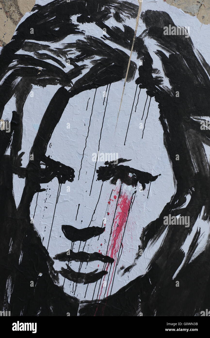 Street Art in Paris representing a sad woman crying blood Stock Photo ...