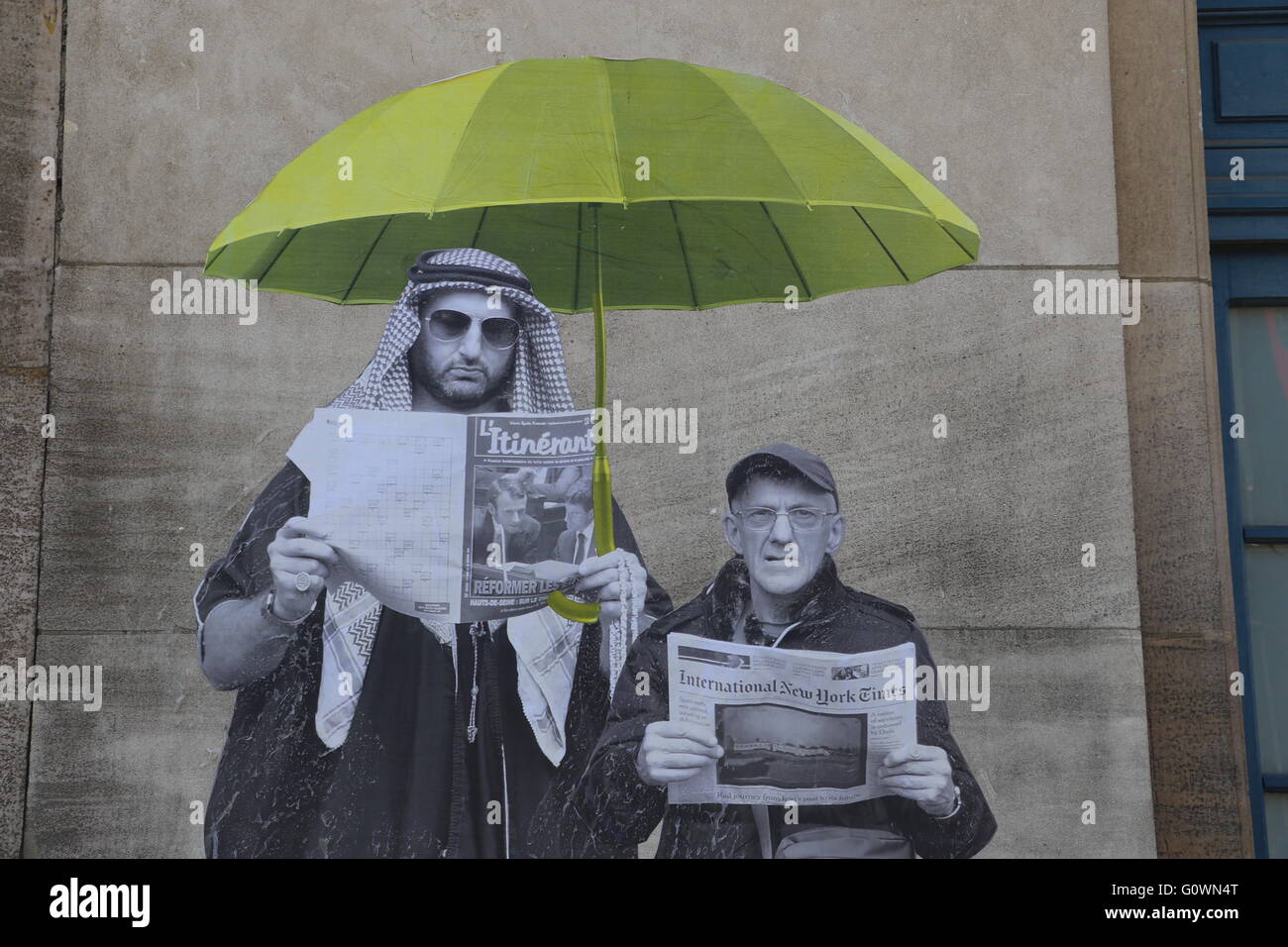 Street art in Paris representing an homeless with a rich arabic man ...