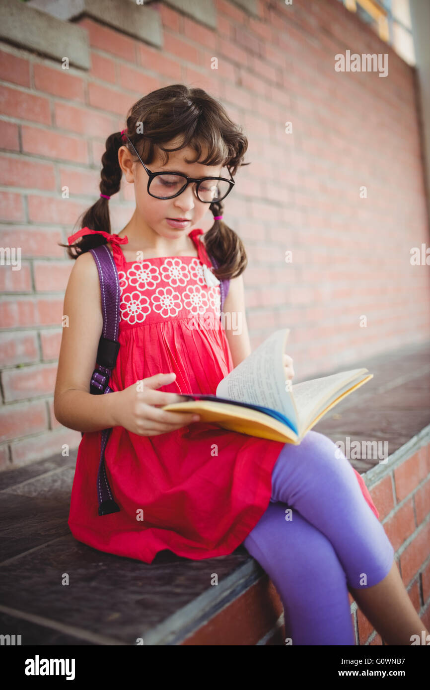 Girl reading a book outside Stock Photo - Alamy