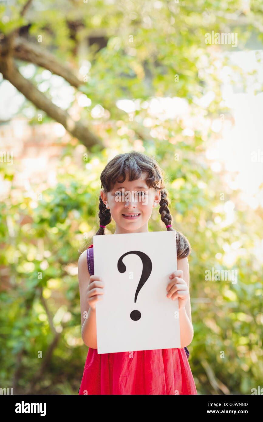 Girl holding a sign with a question mark Stock Photo - Alamy