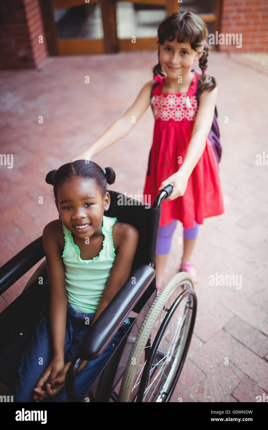 Girl pushing a friend Stock Photo - Alamy