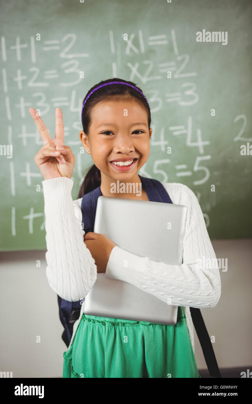 Schoolgirl doing the peace sign Stock Photo - Alamy