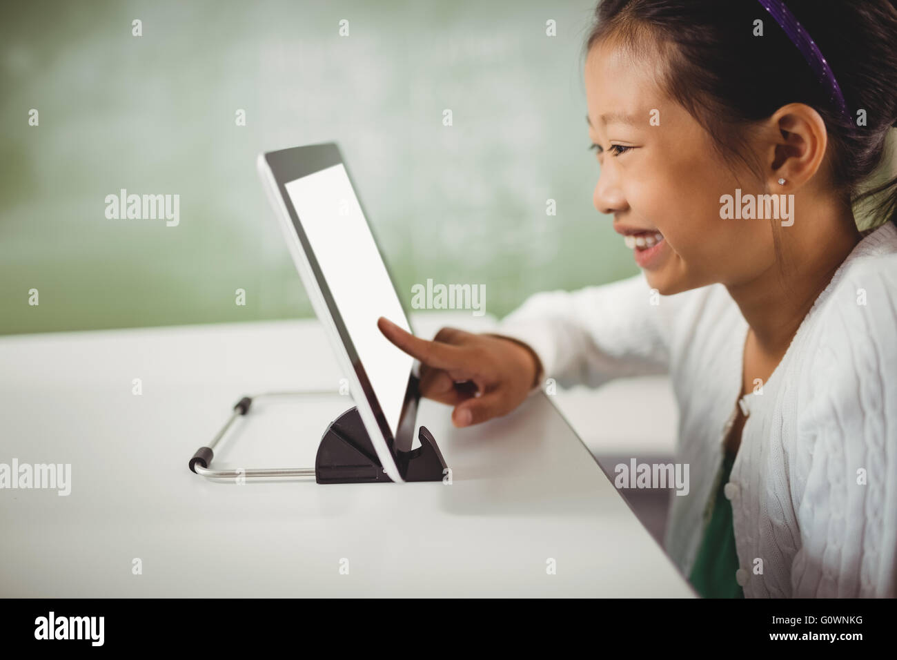 Happy cute girl using digital hi-res stock photography and images - Alamy