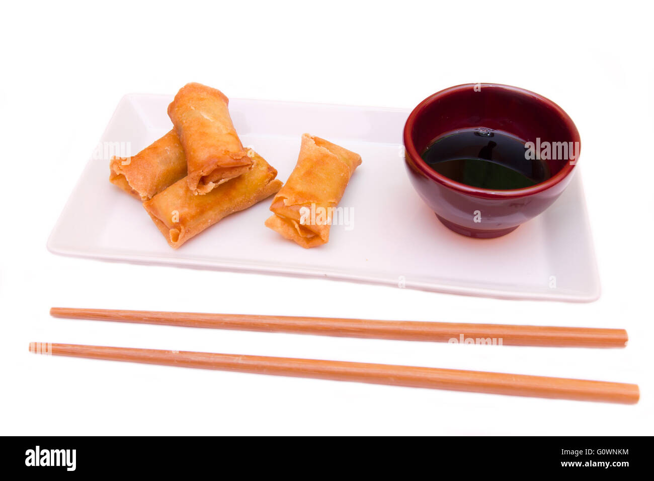 Tray with spring rolls on a white background Stock Photo - Alamy