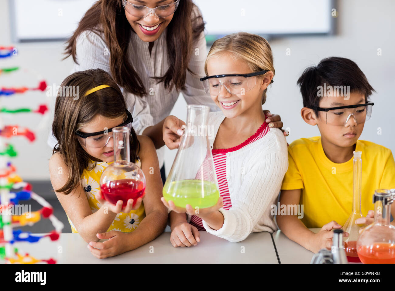Teacher helping pupils doing science Stock Photo - Alamy Teacher helping pupils doing science Stock Photo - Alamy