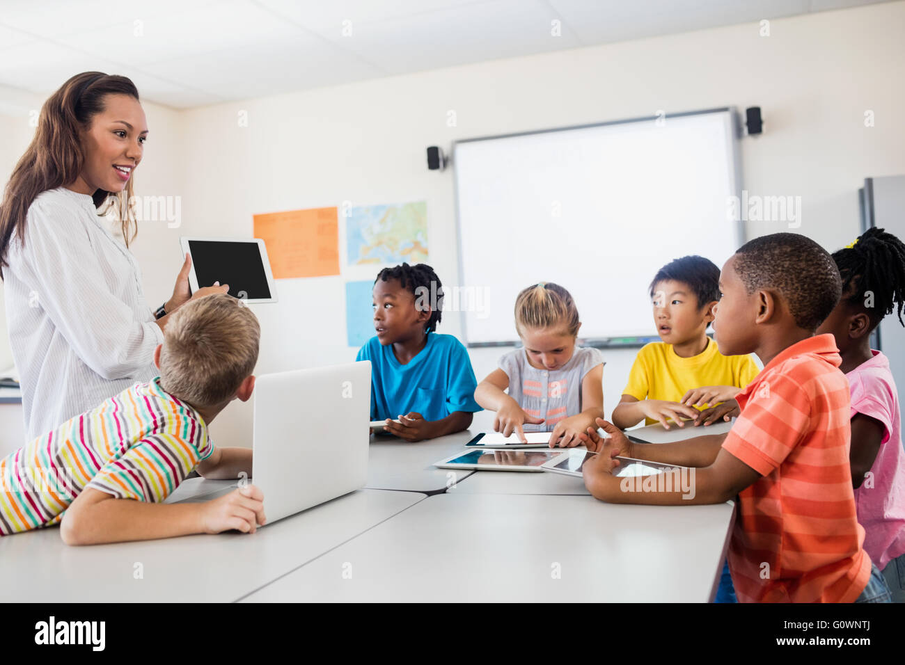 A teacher giving lesson with new technology Stock Photo - Alamy