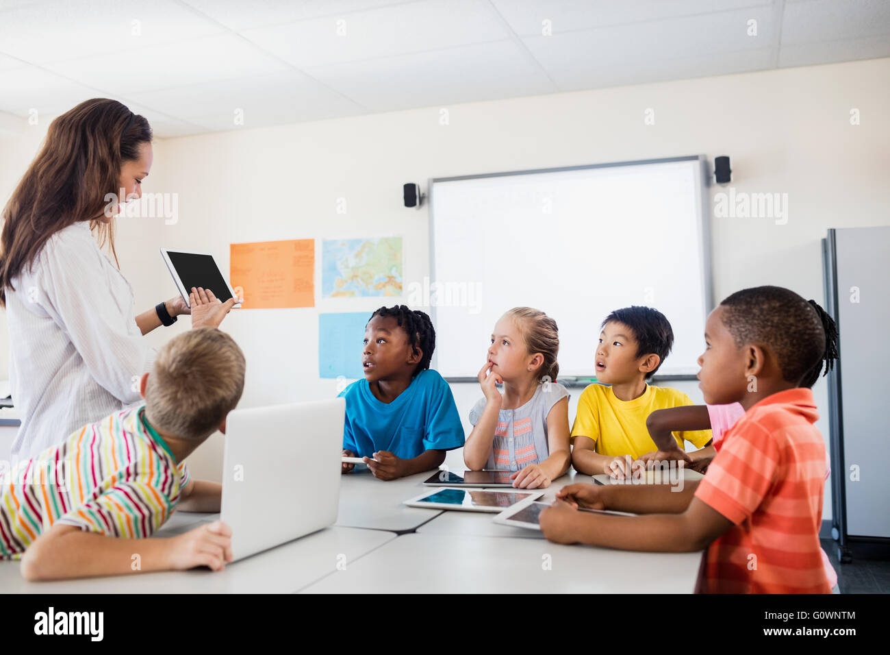 Pupils listening the teacher Stock Photo - Alamy