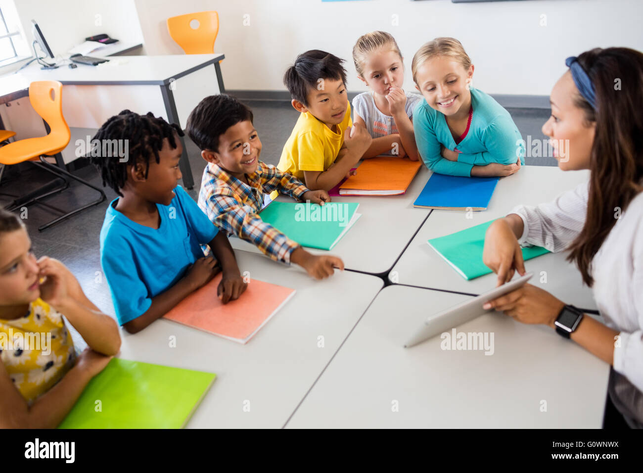 Aerial view of pupils and teacher with tablet Stock Photo - Alamy