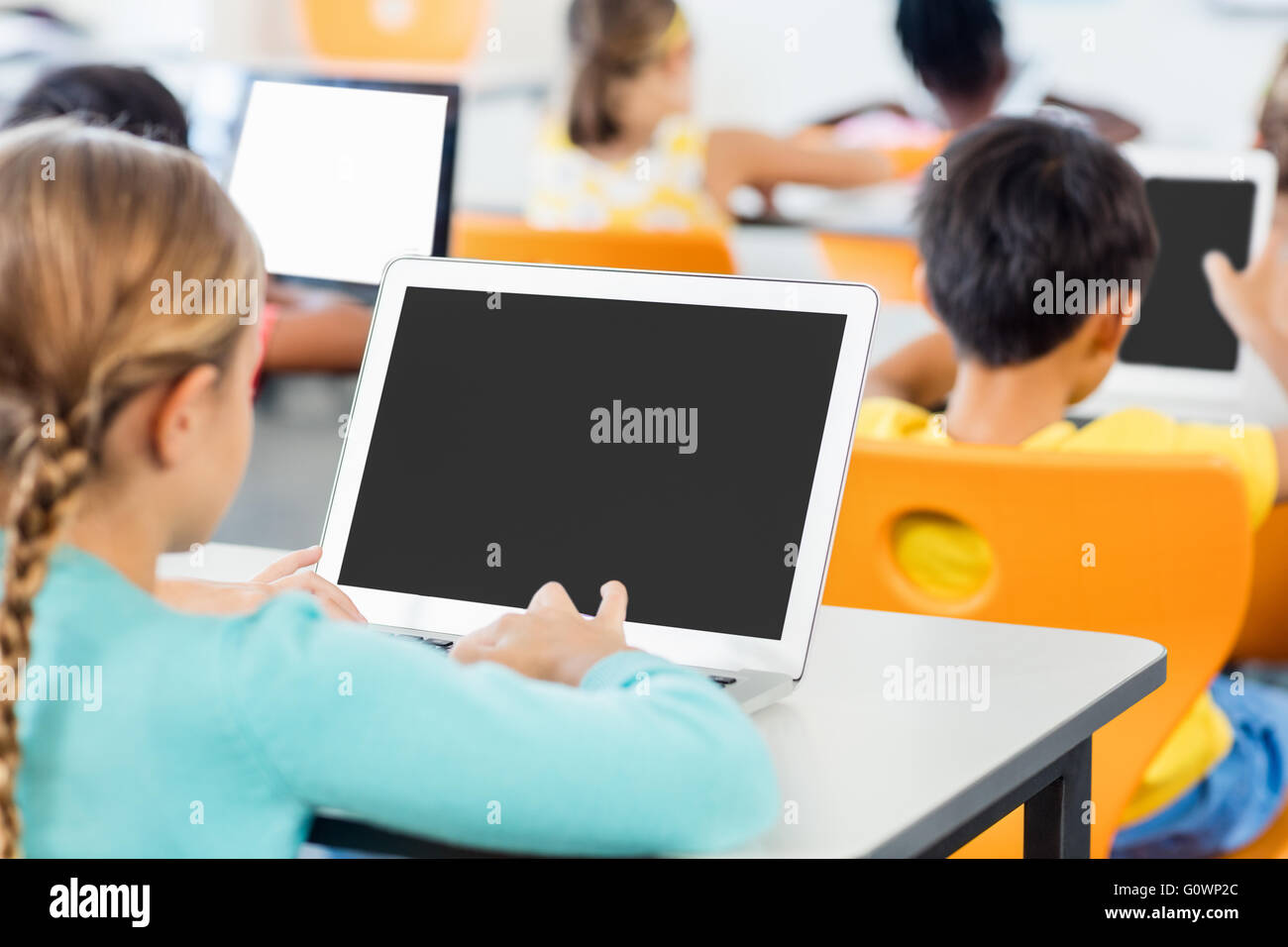 Rear view of pupils working in classroom with laptop Stock Photo - Alamy