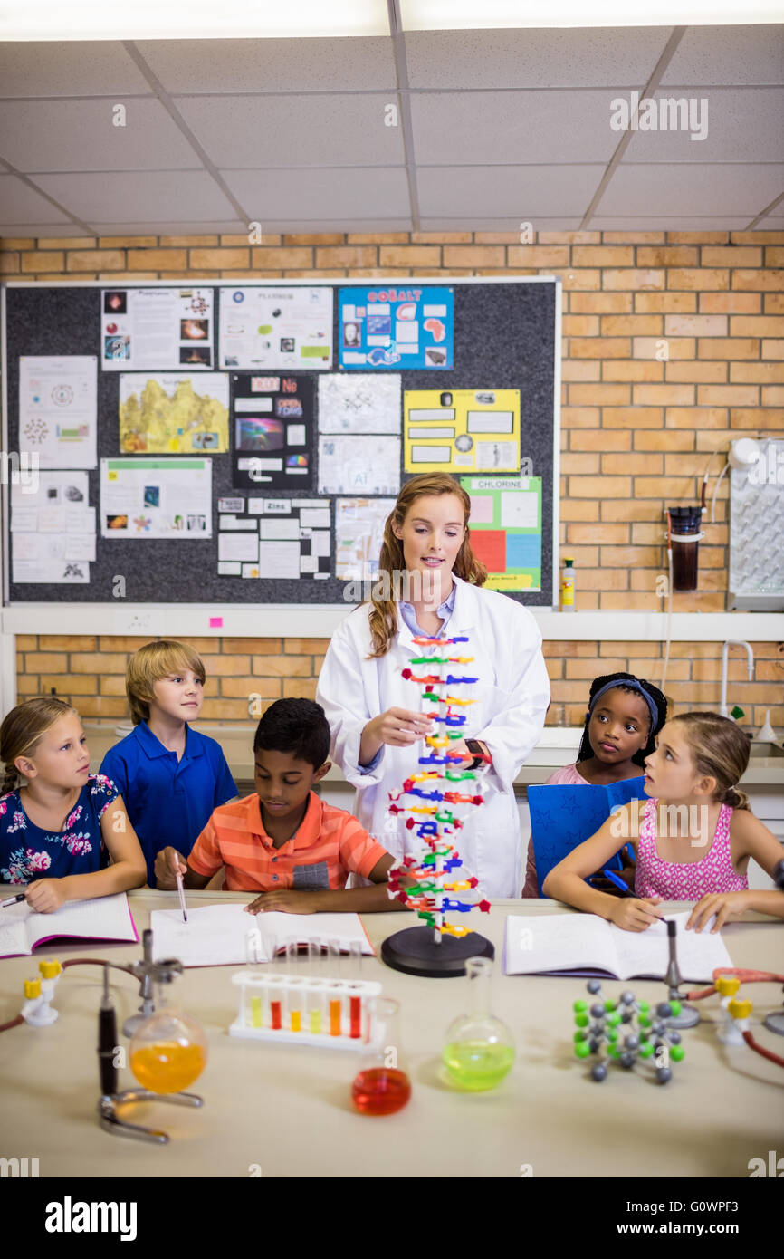 Teacher giving lesson to her students Stock Photo - Alamy