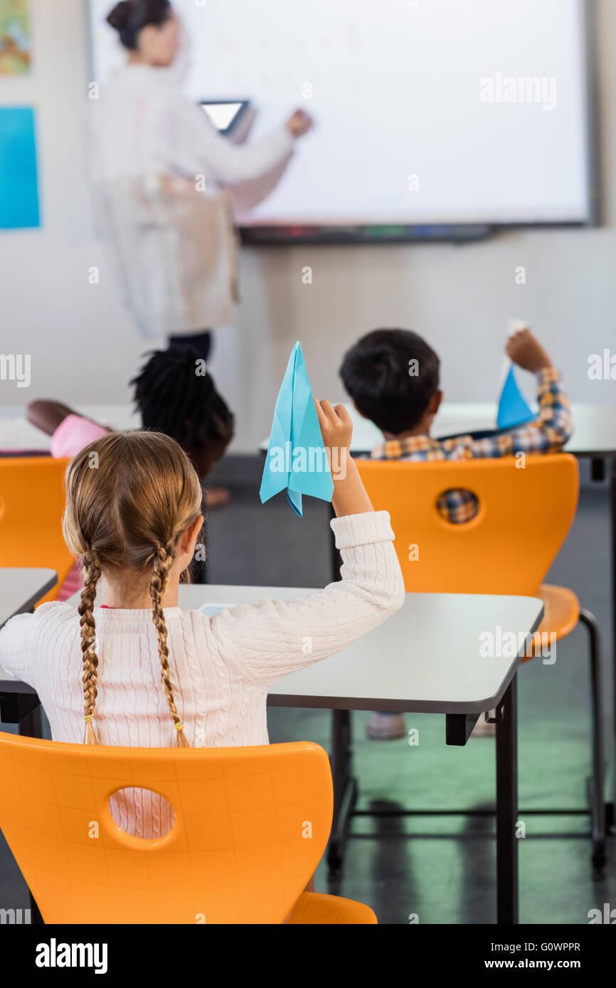 Students throwing paper plane Stock Photo - Alamy