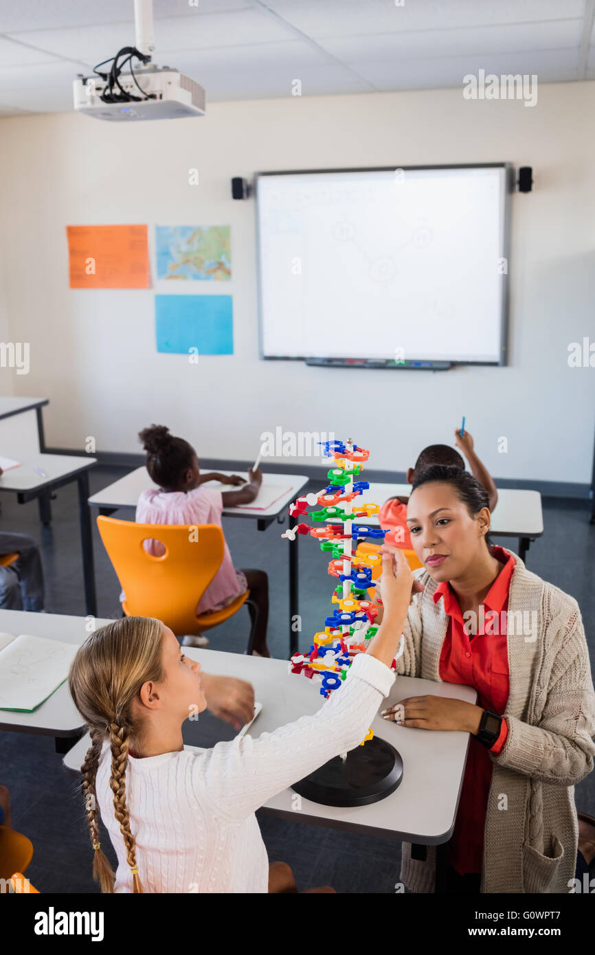 Teacher giving lesson to her students Stock Photo - Alamy