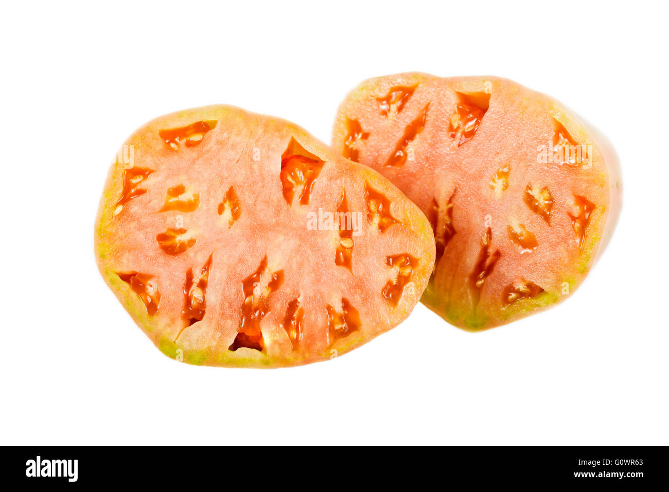 Sliced near ripe ox heart tomato, Solanum lycopersicum, showing many ...