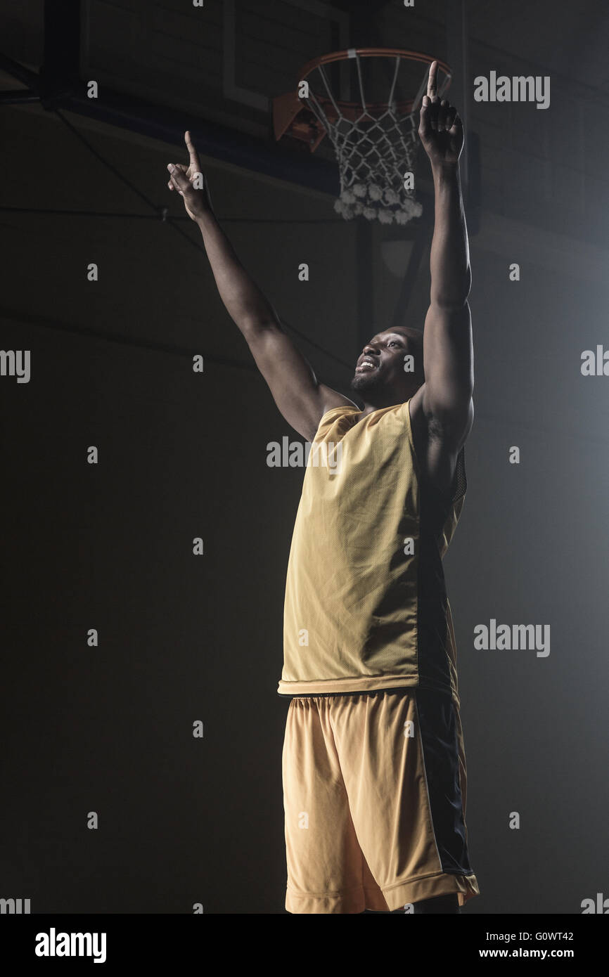 Portrait of basketball player throwing arms for the victory Stock Photo ...