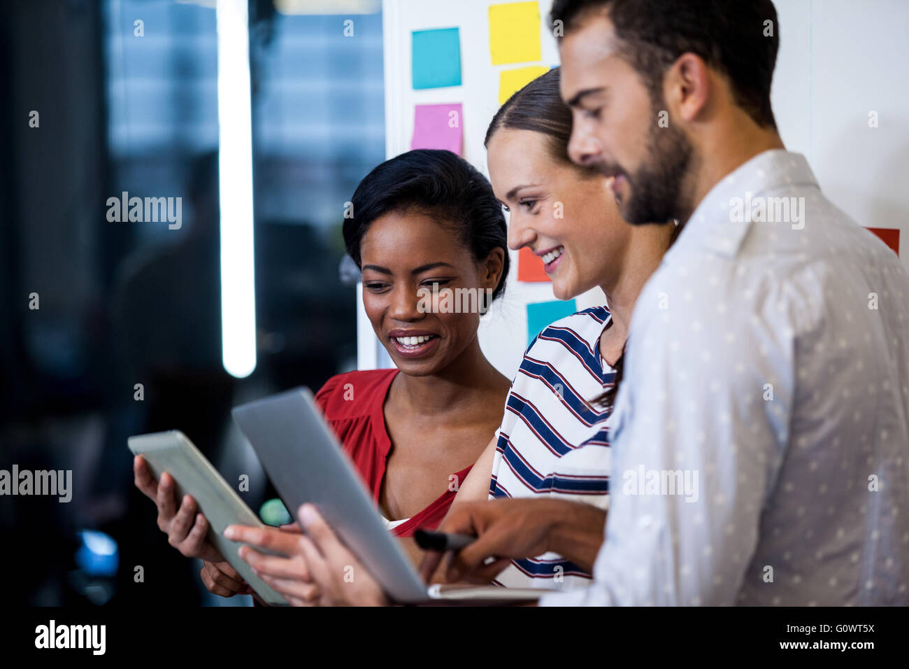 A young business team discussing together Stock Photo - Alamy