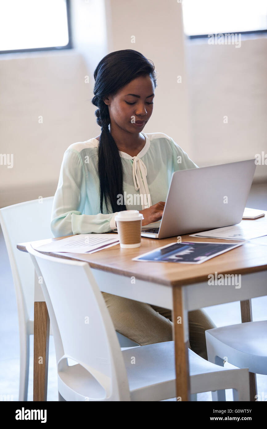 A serious woman working on laptop Stock Photo - Alamy