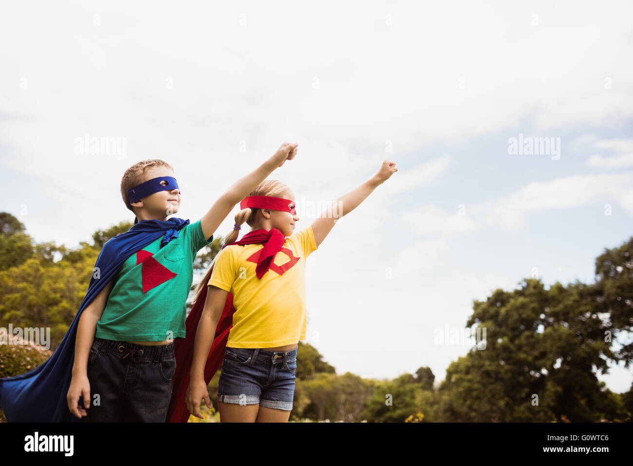 Two cute children pretending to fly in superhero costume Stock Photo ...