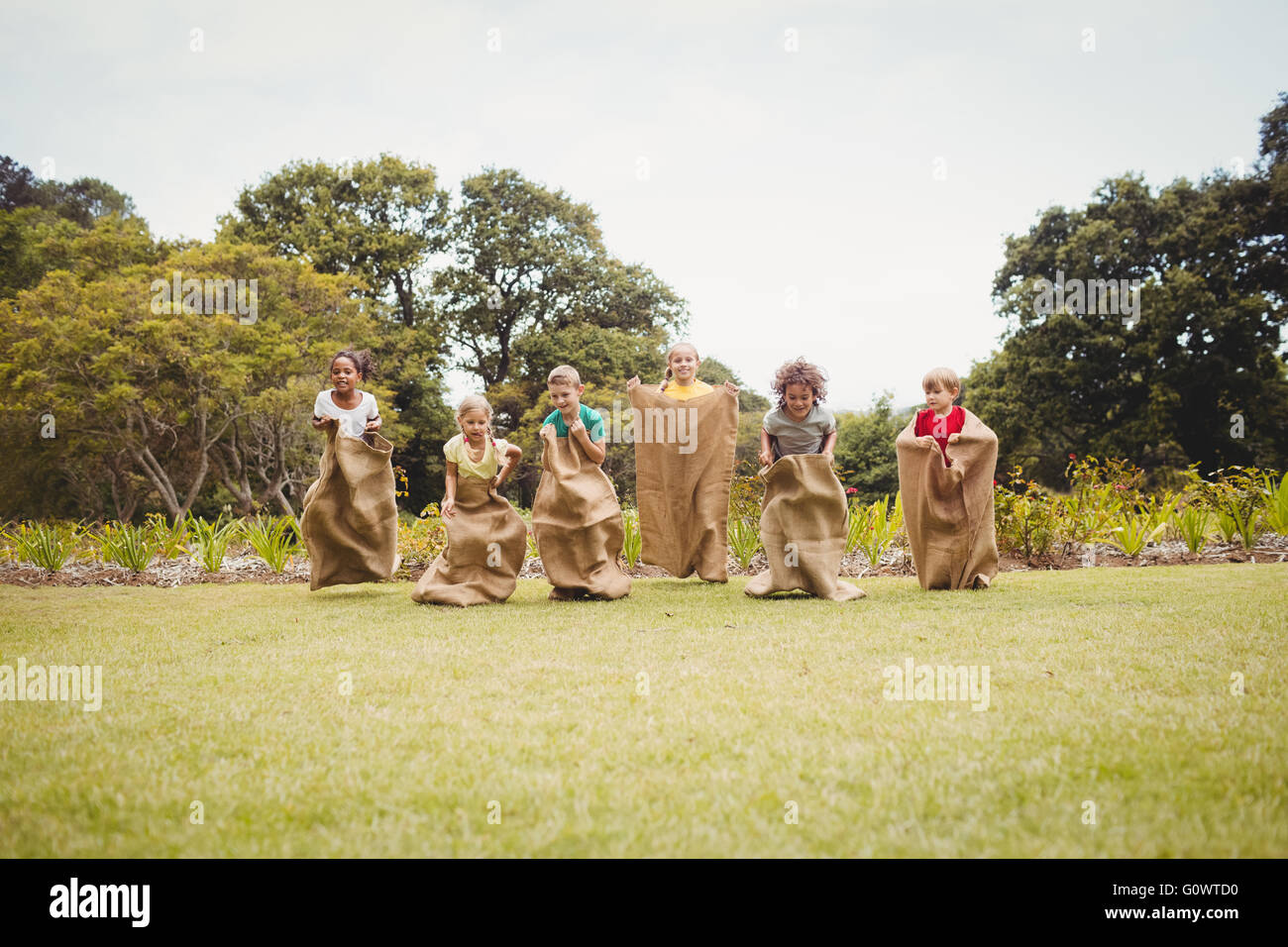 Children having a sack race Stock Photo - Alamy