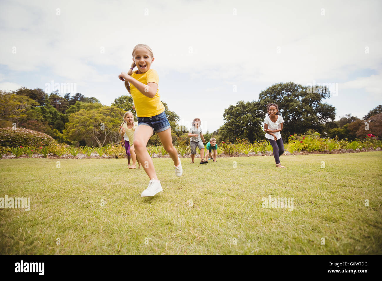 Facing view of children running Stock Photo - Alamy