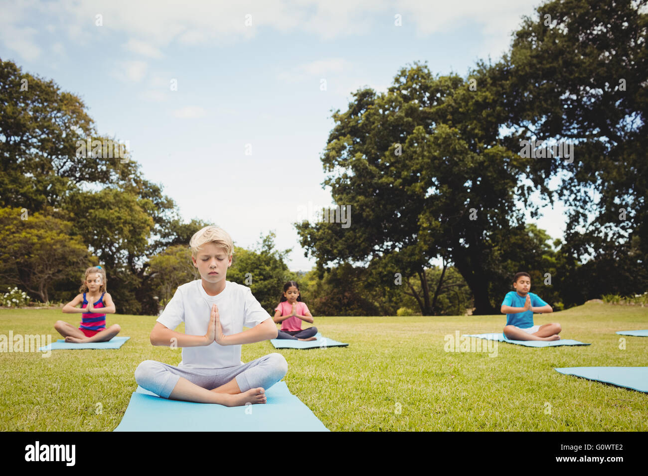 Front view of children doing yoga Stock Photo - Alamy