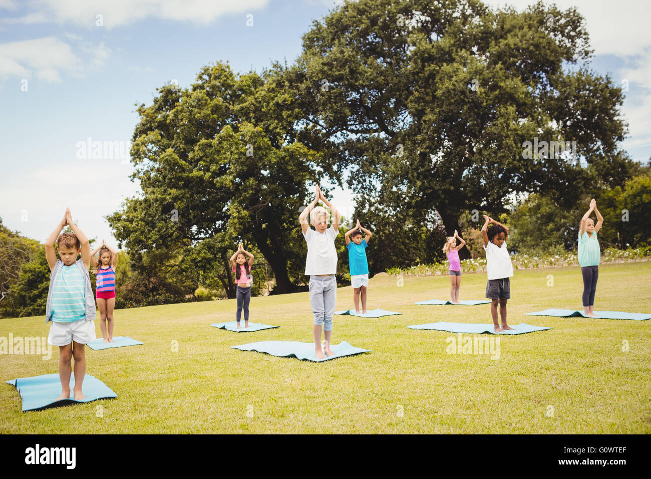 Doing standing yoga hi-res stock photography and images - Alamy