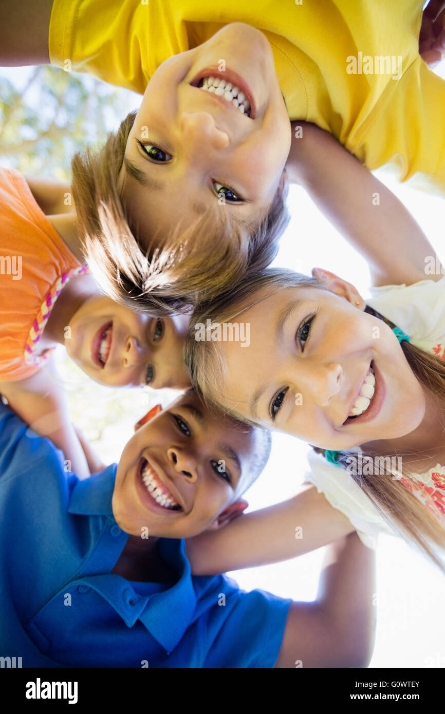 smiling children forming a huddle in circle Stock Photo - Alamy