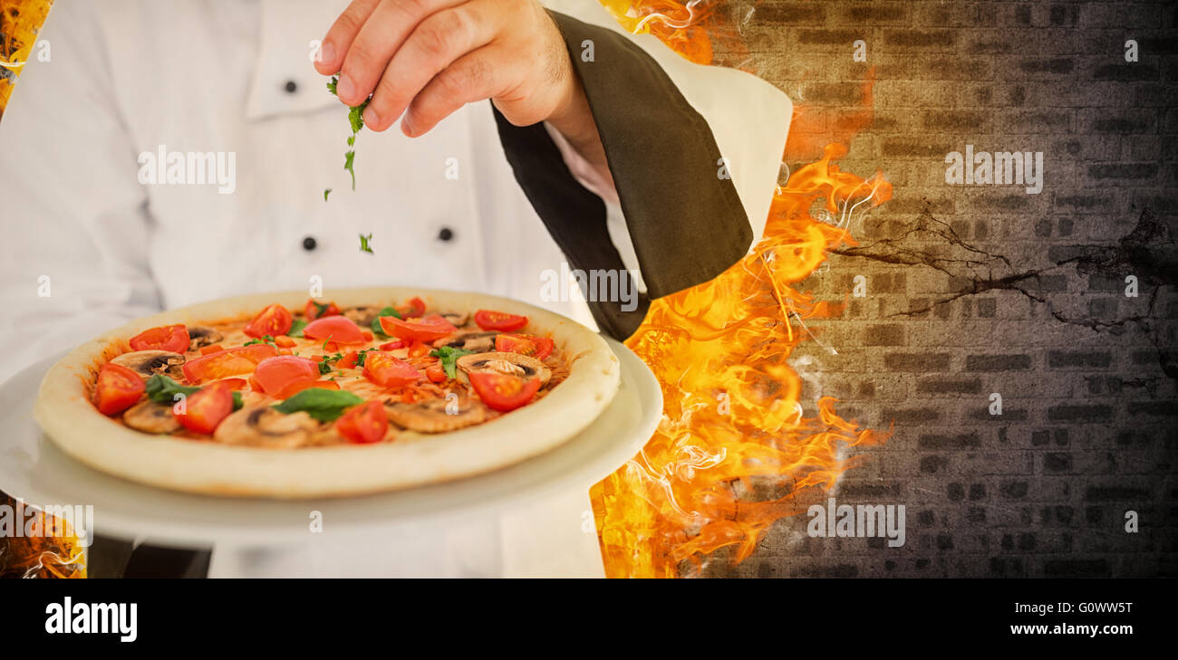 Composite image of close up on a chef holding a pizza Stock Photo - Alamy