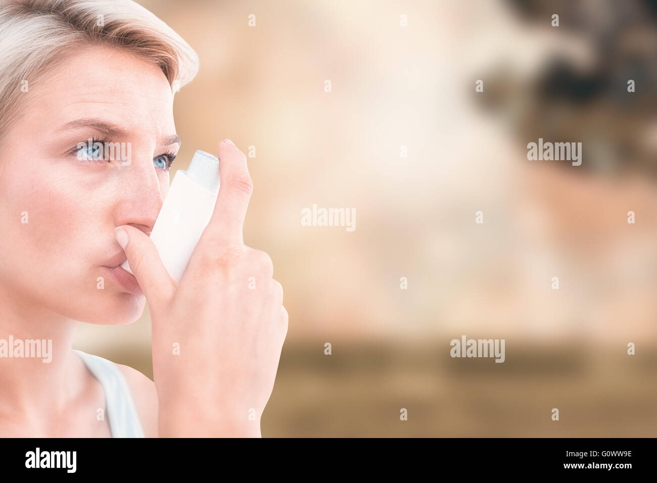 Composite image of blonde woman taking her inhaler Stock Photo - Alamy