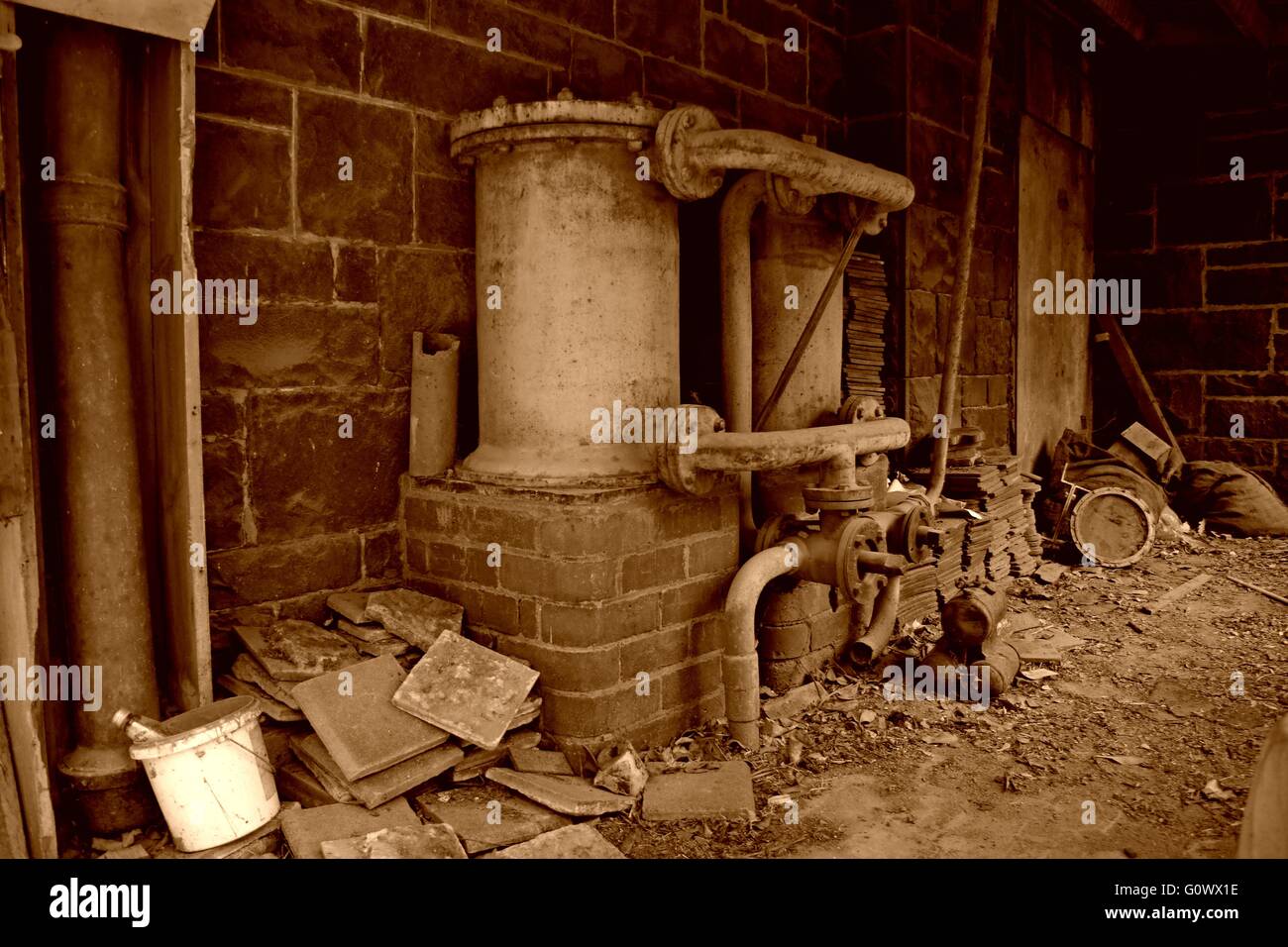Old abandoned water supply installation at an old house in monochrome ...