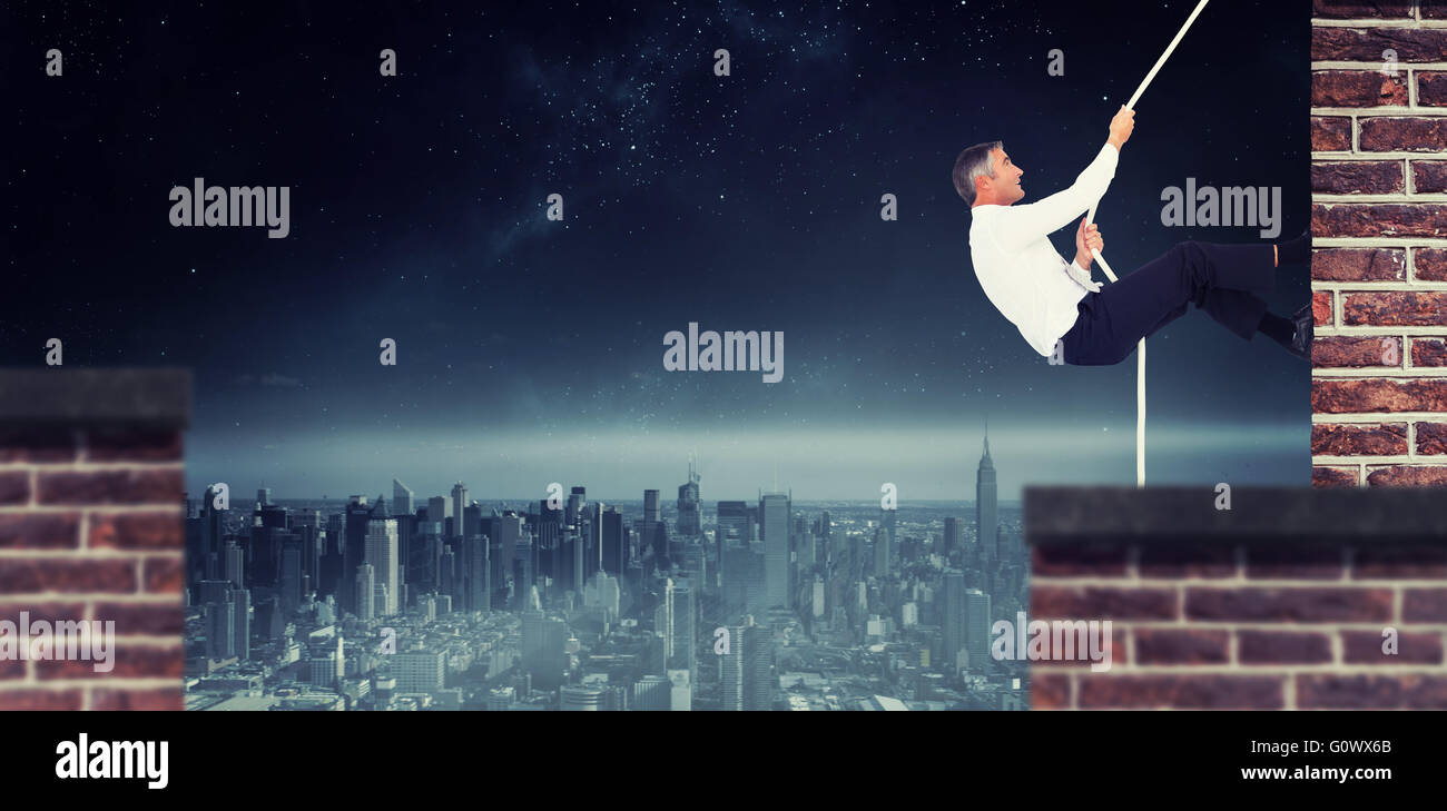 Composite image of businessman pulling rope while sitting on cube Stock ...