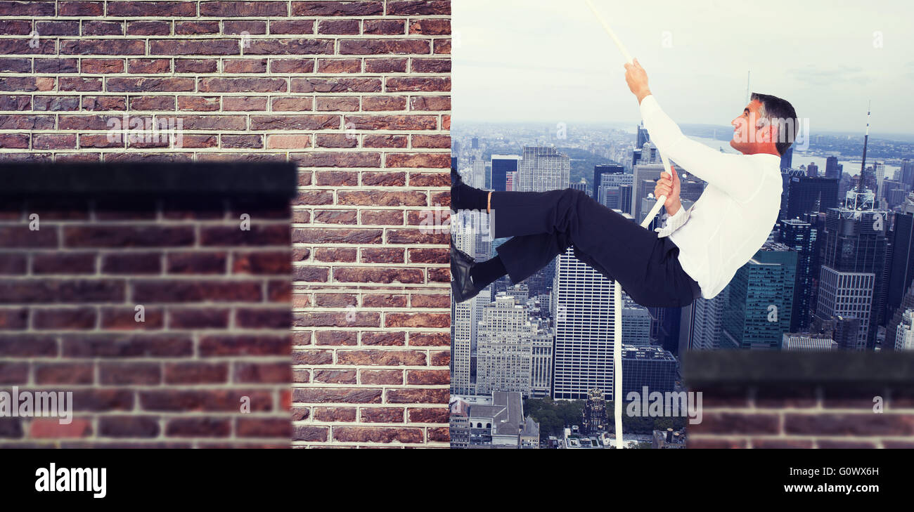 Composite image of businessman pulling rope while sitting on cube Stock ...