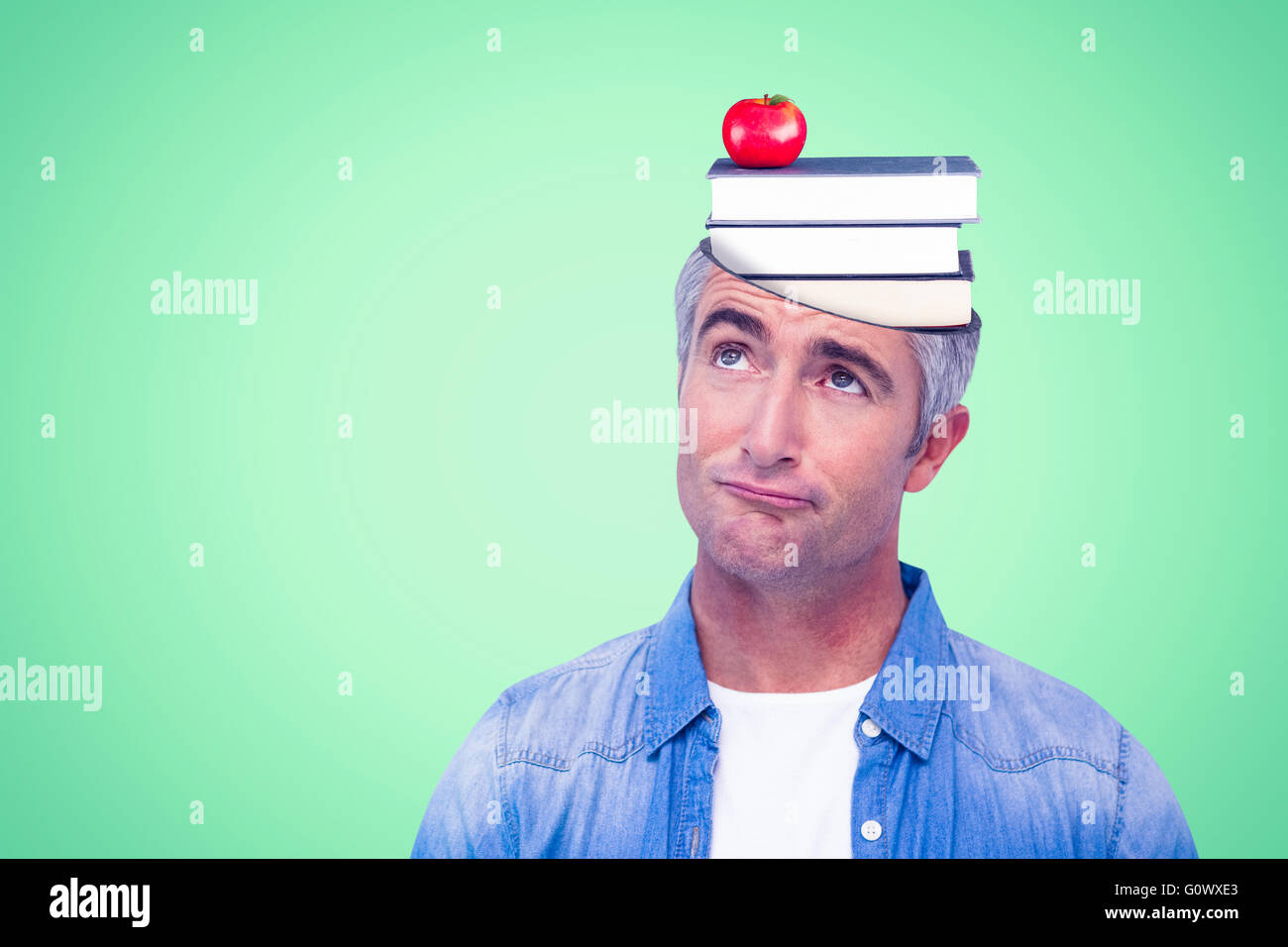 Composite image of confused man with grey hair thinking Stock Photo - Alamy