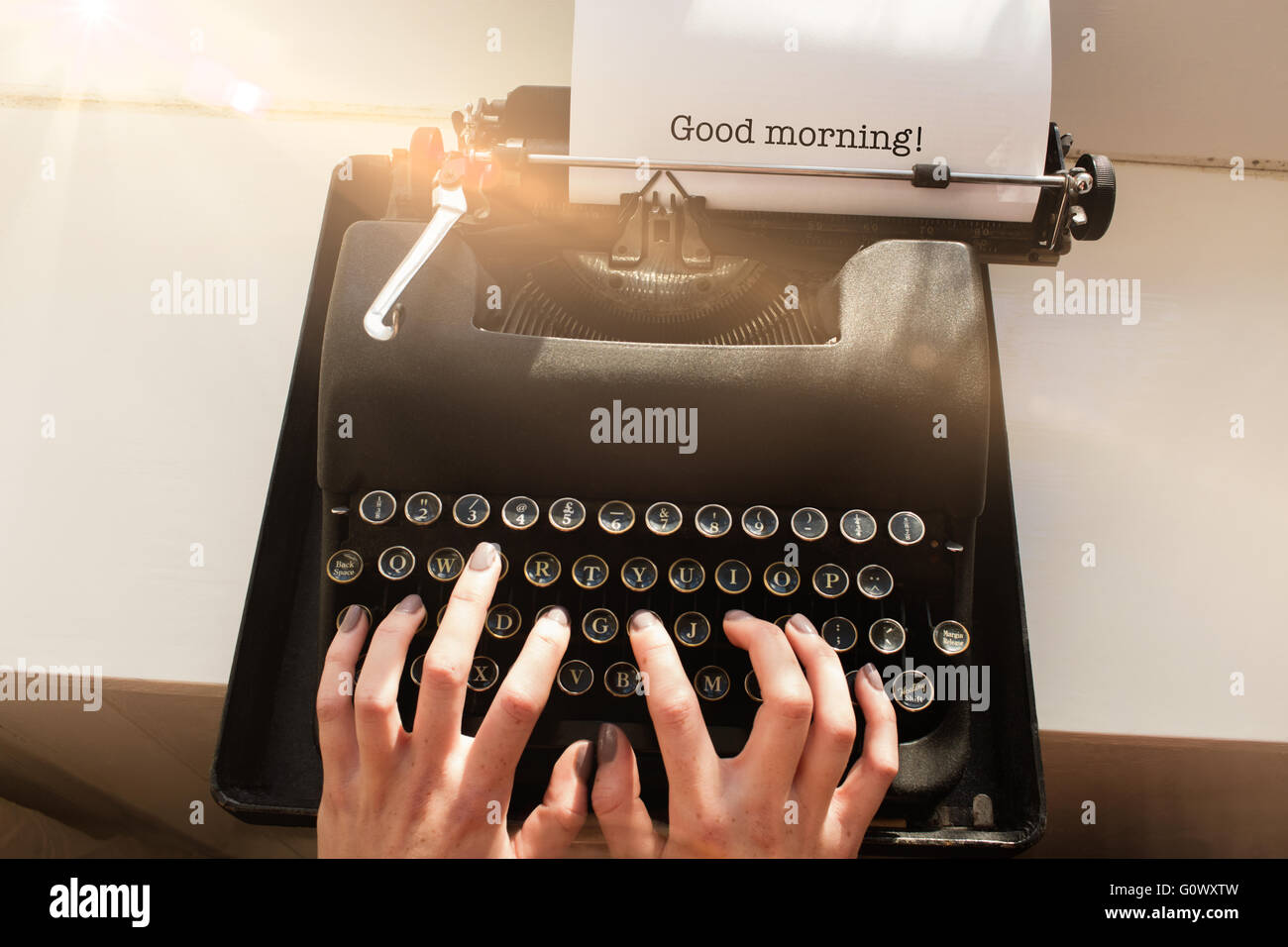 Good morning! against womans hand typing on typewriter Stock Photo - Alamy