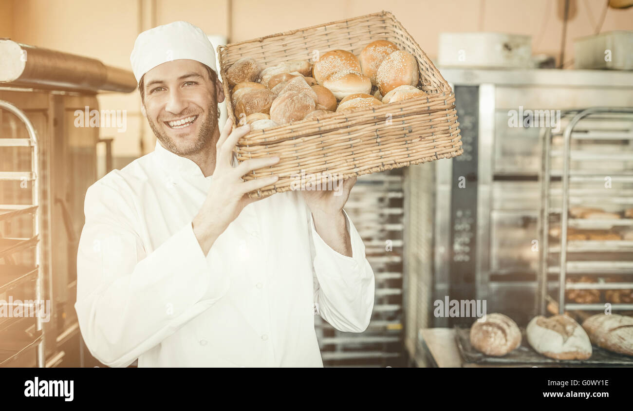 Baker holding basket of bread Stock Photo - Alamy