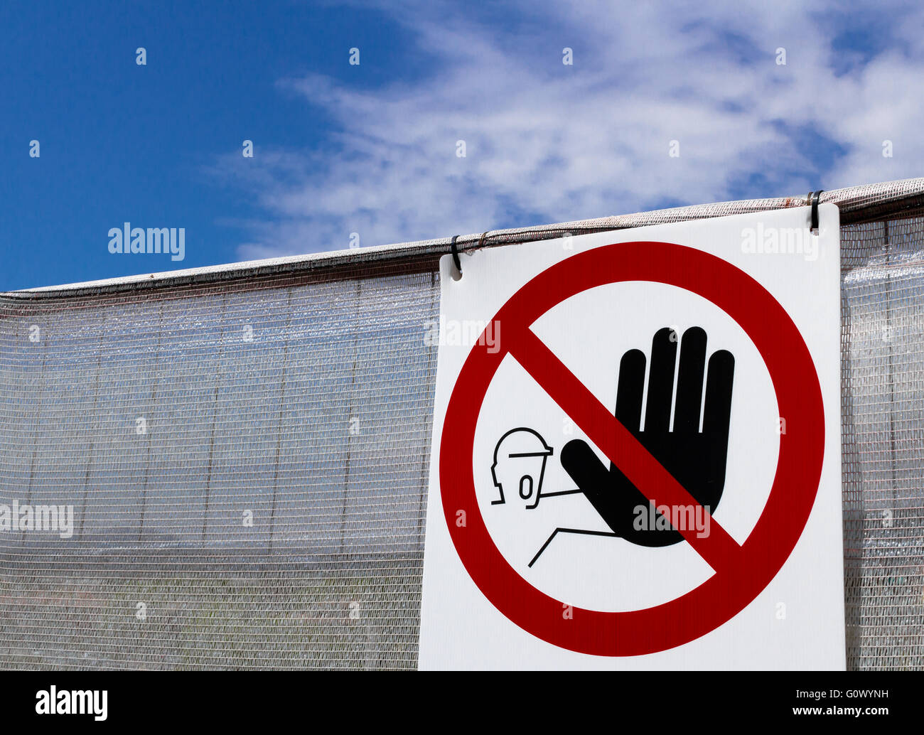 No entry sign on the fence in construction site and blue sky in the ...