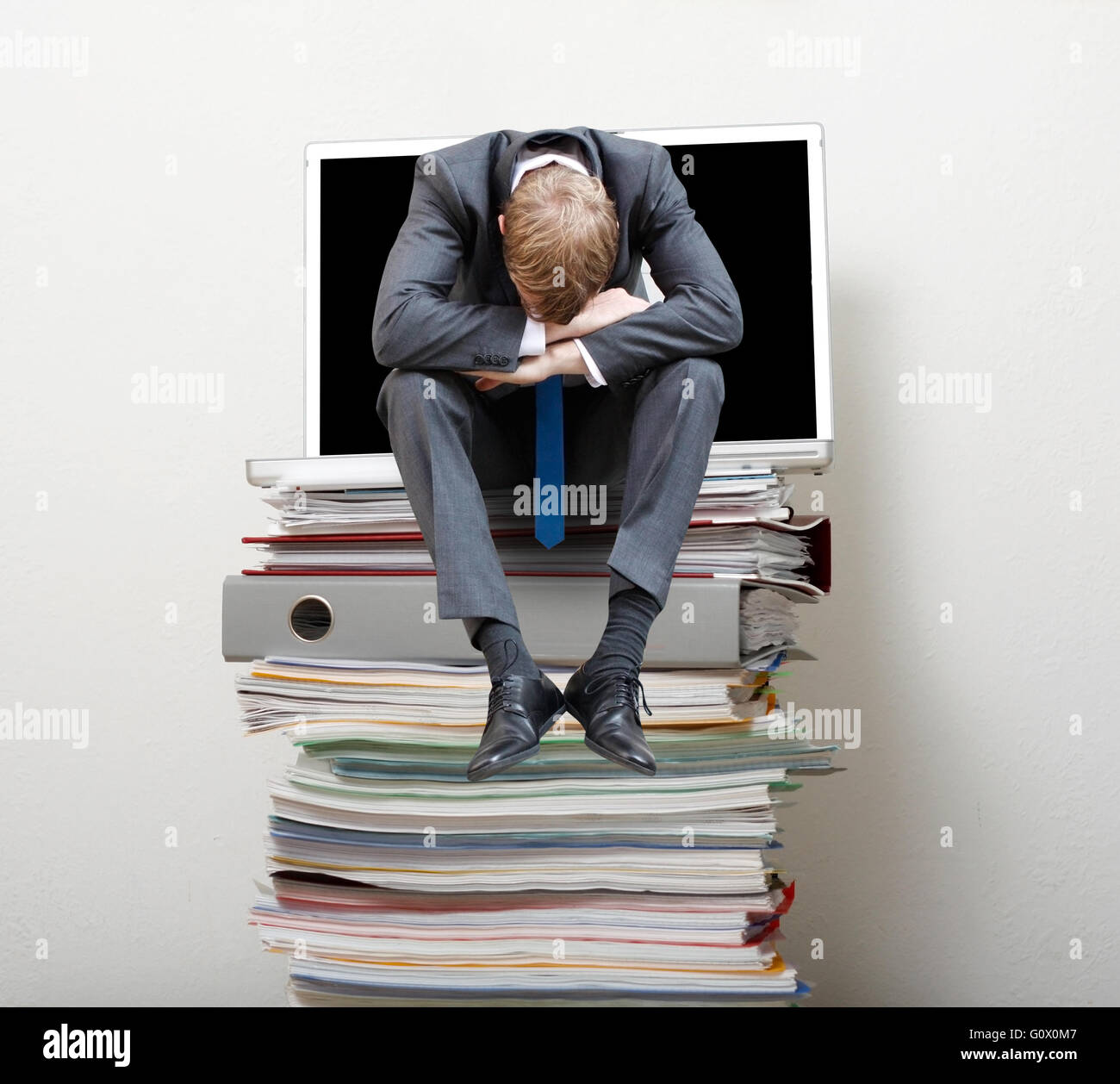 An overworked businessman Stock Photo - Alamy